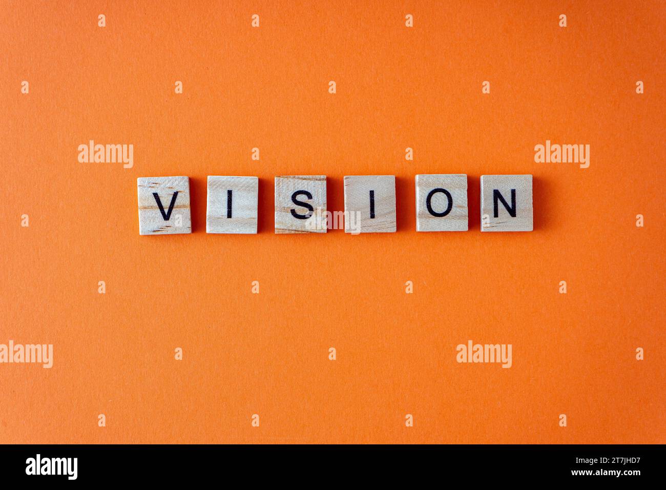 VISION wood word on compressed board with human's finger at N letter ...