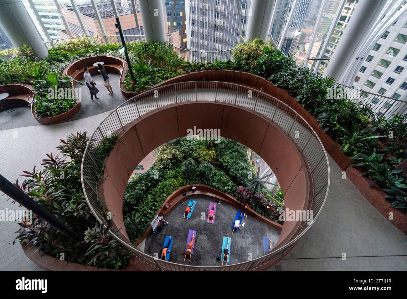 A yoga class takes place on the Green Oasis botanical promenade at the ...