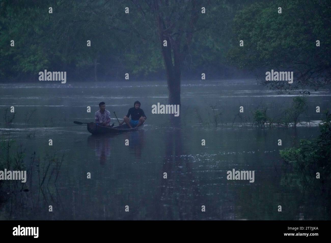 Indigenous Tembe men navigate along the Guama River, in the Tenetehar ...