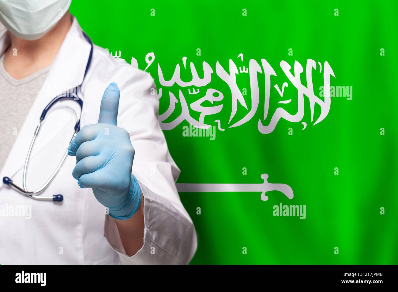 Saudi Arabian doctor's hand showing thumb up positive gesture on flag ...