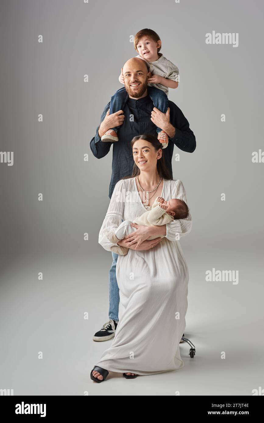 cheerful family of four wearing classy stylish outfits and posing ...