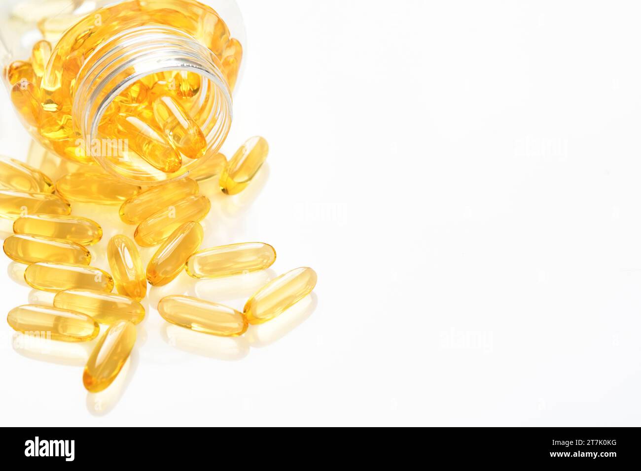 Capsules. Yellow pills isolated on white. Close up capsules with ...