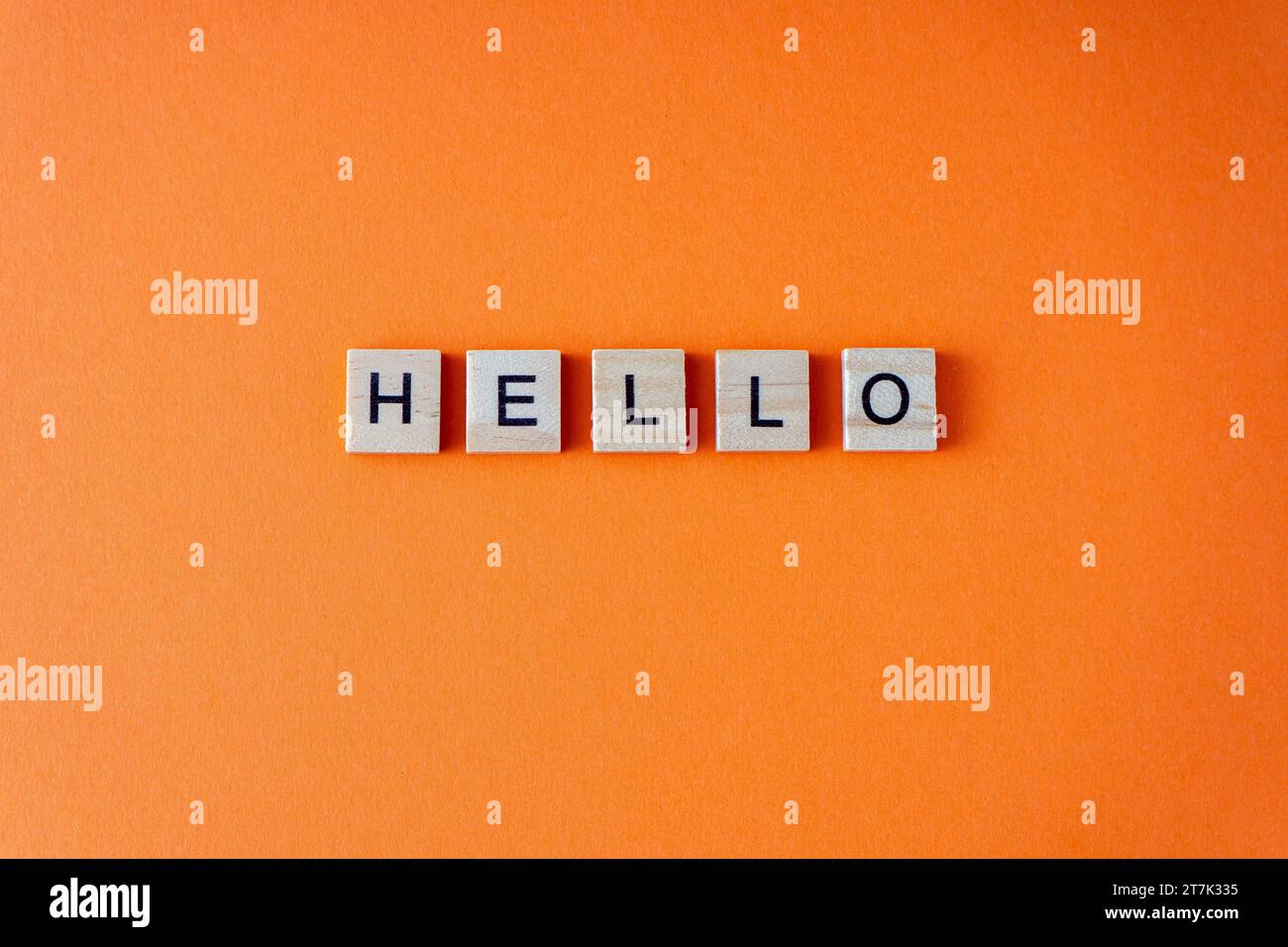 Hello word. The phrase is laid out in wooden letters top view. Orange ...