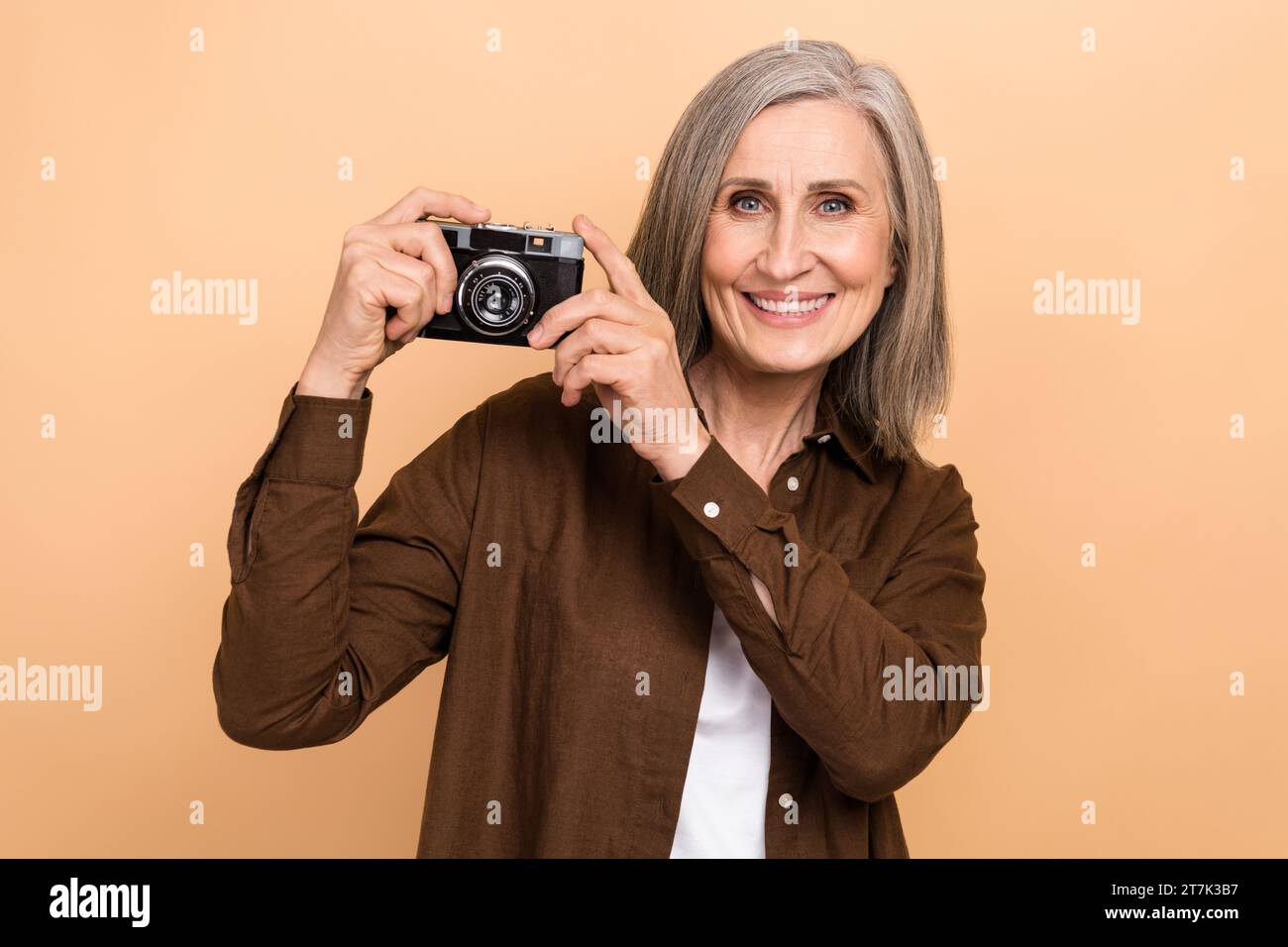 Photo of nice satisfied aged person toothy smile hands hold retro photo ...