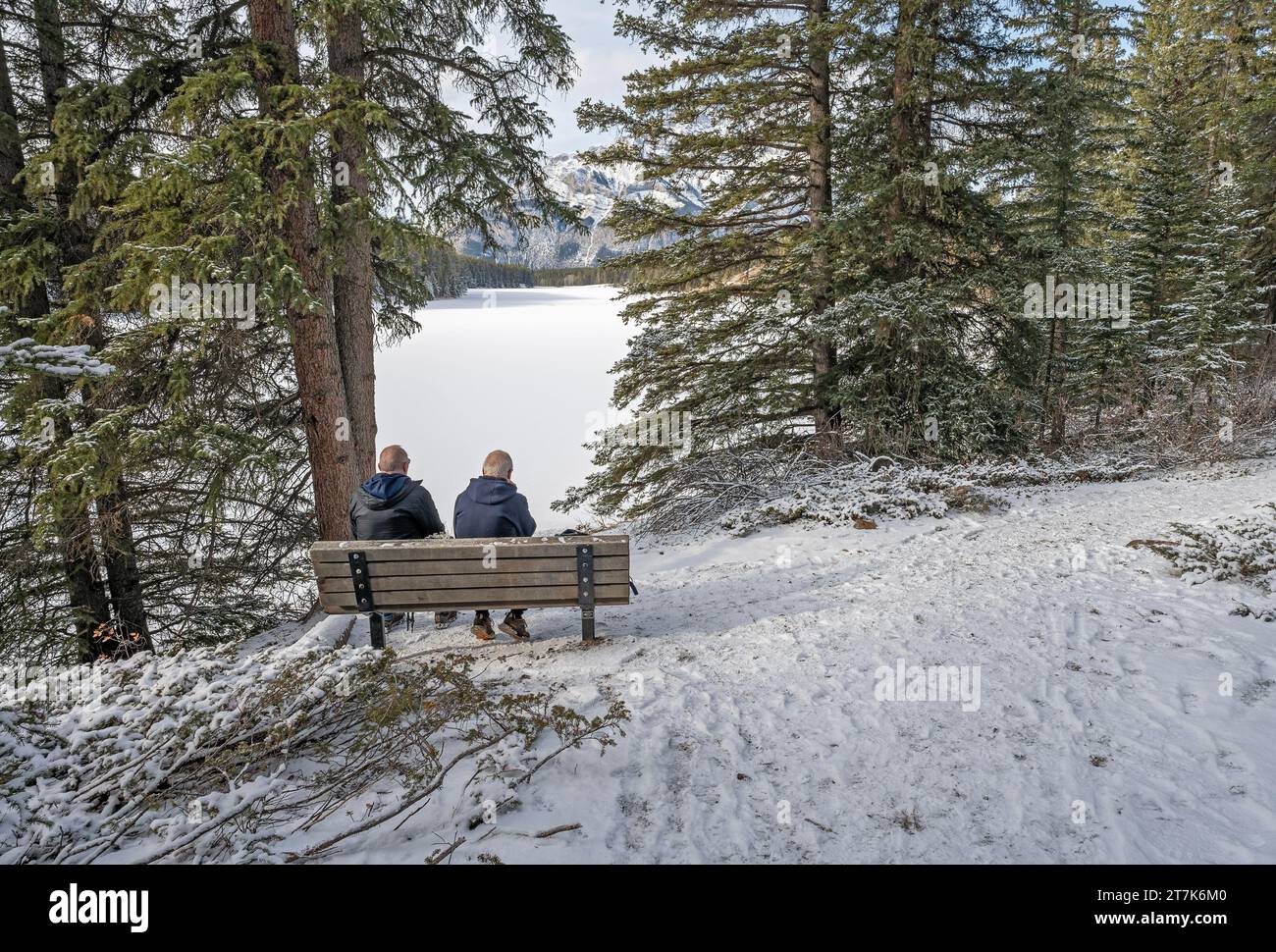 Banff National Park, Alberta, Canada – November 12, 2023: Two men sit ...