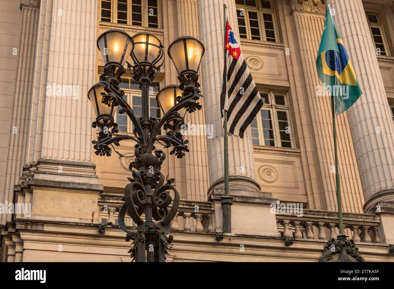 Old lamp lit with the facade of the Santos City Hall building in the ...