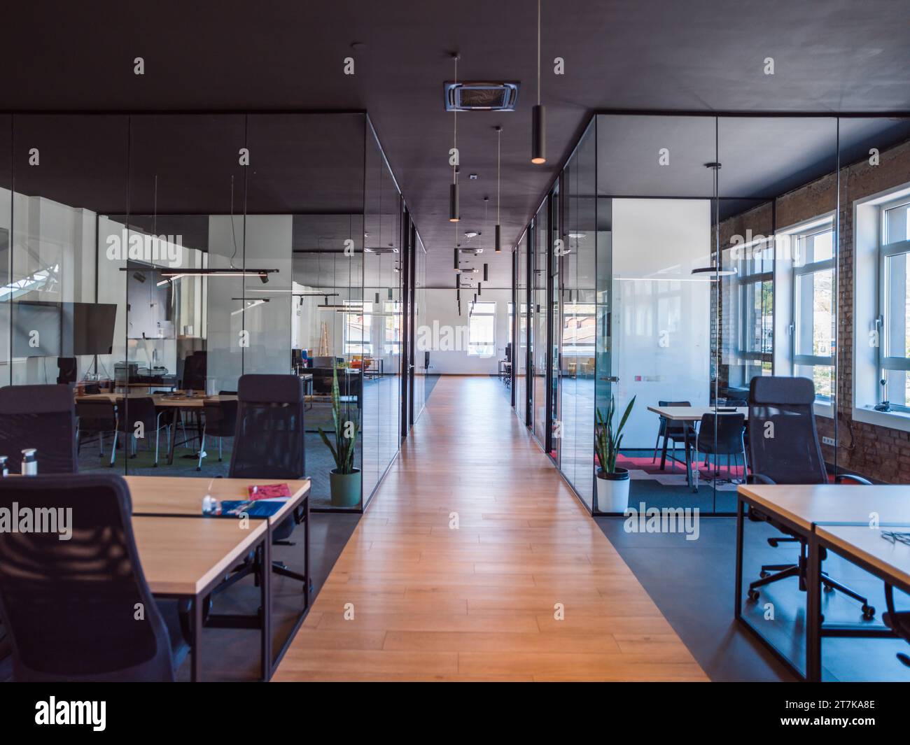 In a setting of modern, glass-walled business startup offices, the open ...