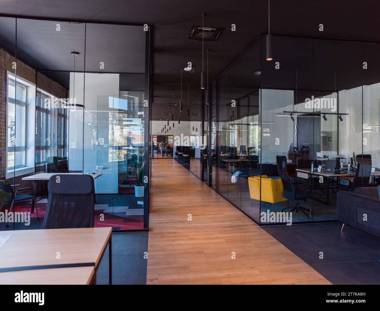In a setting of modern, glass-walled business startup offices, the open ...