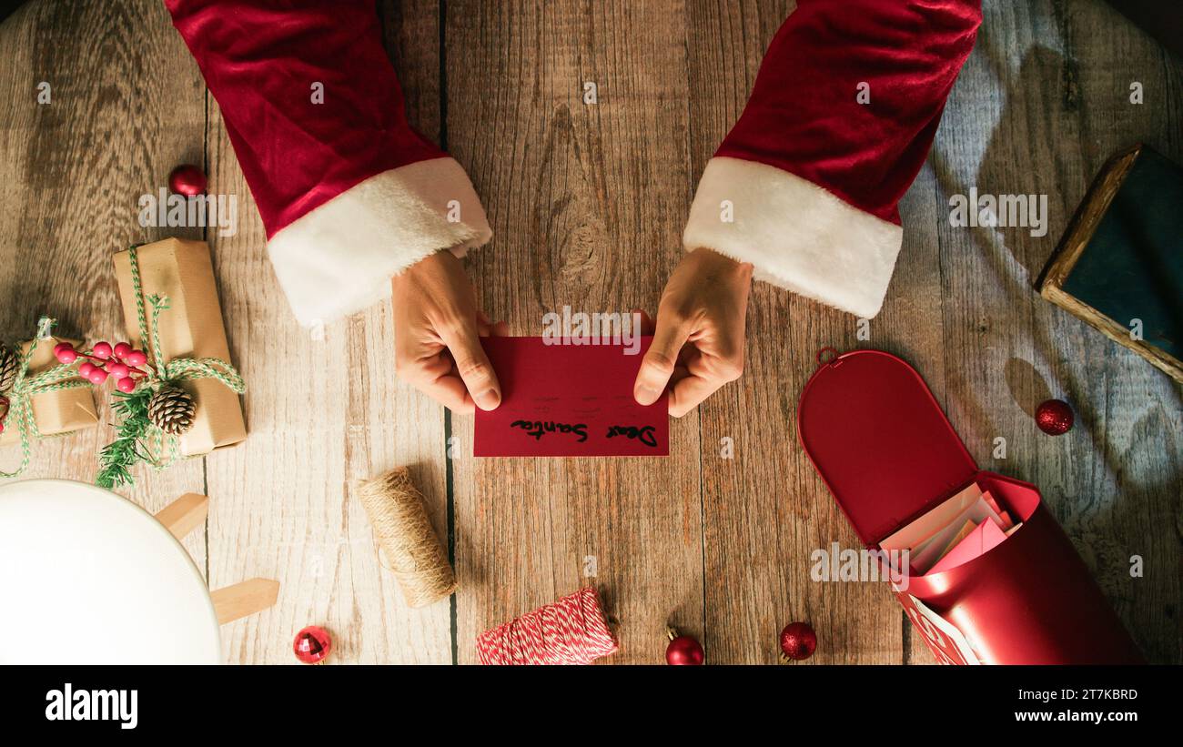 Santa Claus Reading a Christmas Letter Stock Photo - Alamy