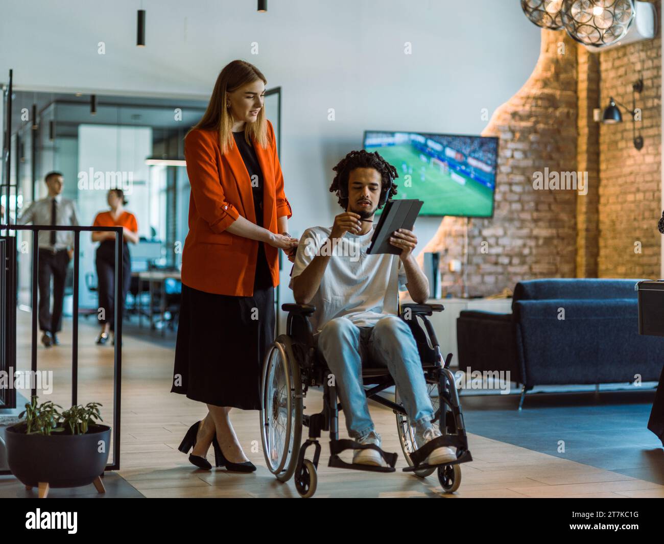 African-American businessman in a wheelchair engages in a collaborative ...