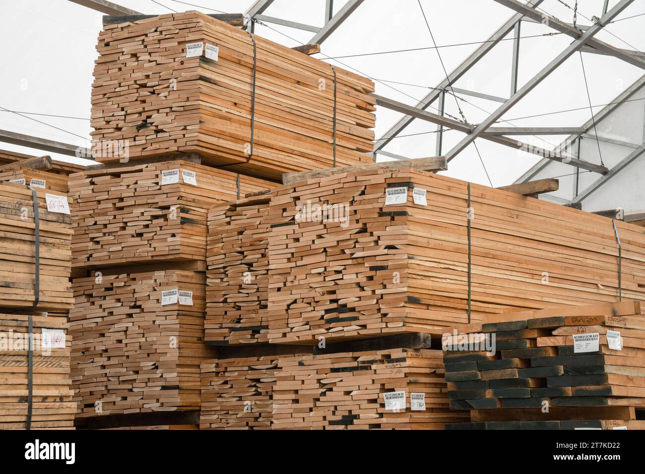 Stacks of lumber being stored in a warehouse Stock Photo - Alamy
