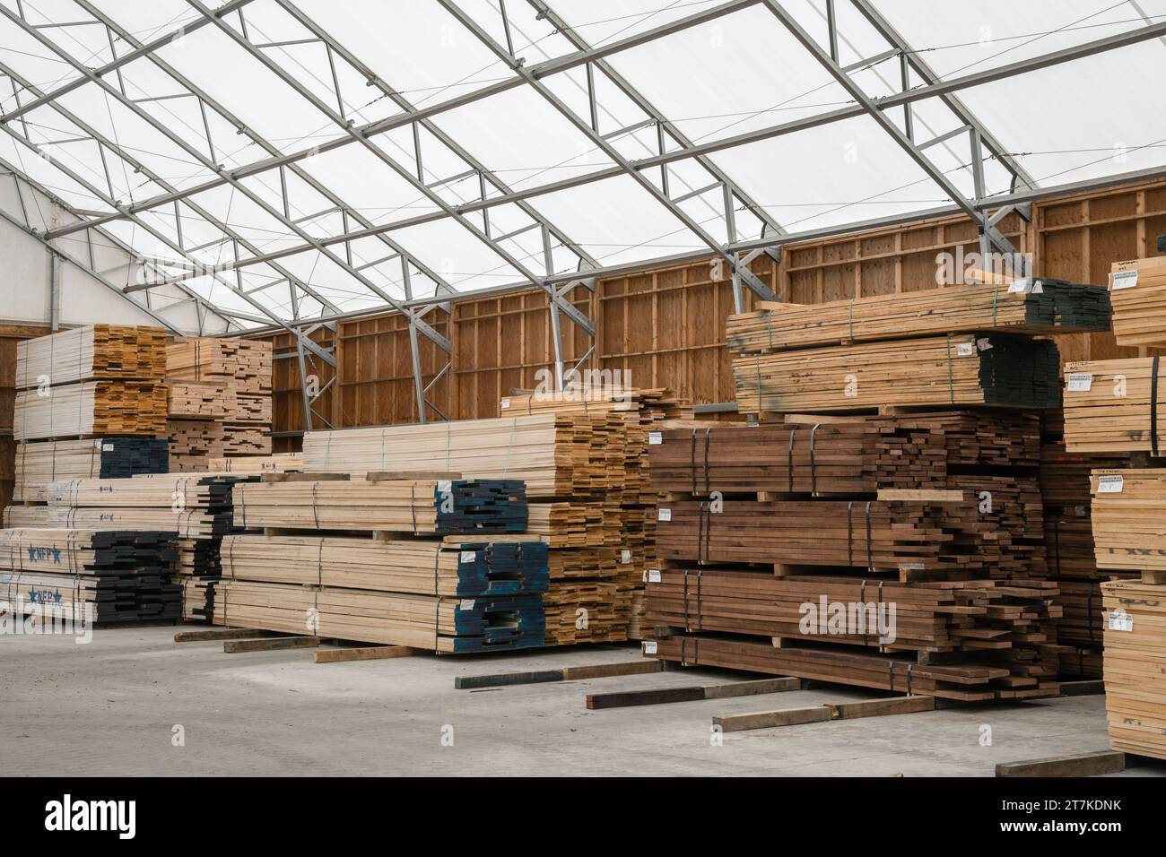 Stacks of lumber being stored in a warehouse Stock Photo - Alamy