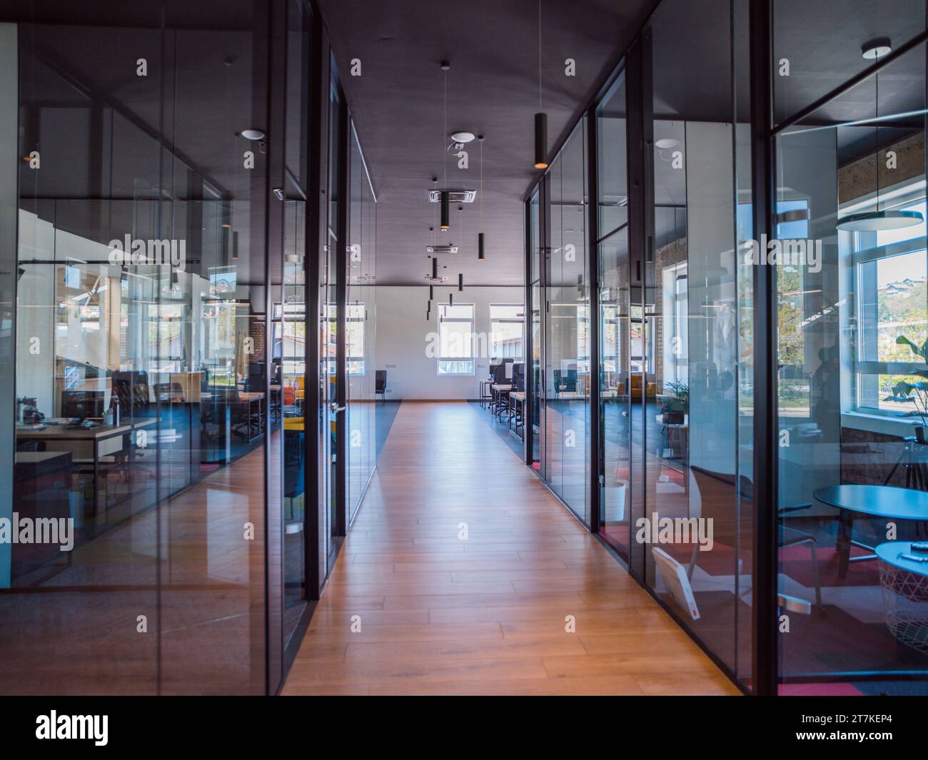 In a setting of modern, glass-walled business startup offices, the open ...