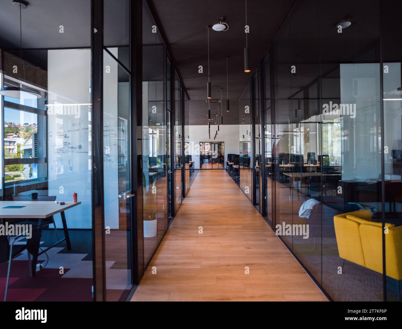 In a setting of modern, glass-walled business startup offices, the open ...