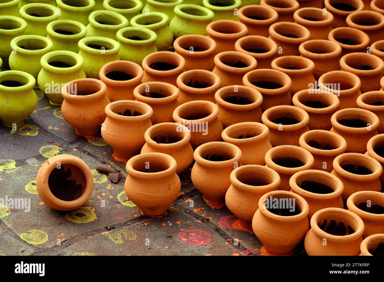 03 November 2023, Pune, India, An Potter applies colour to earthenware ...