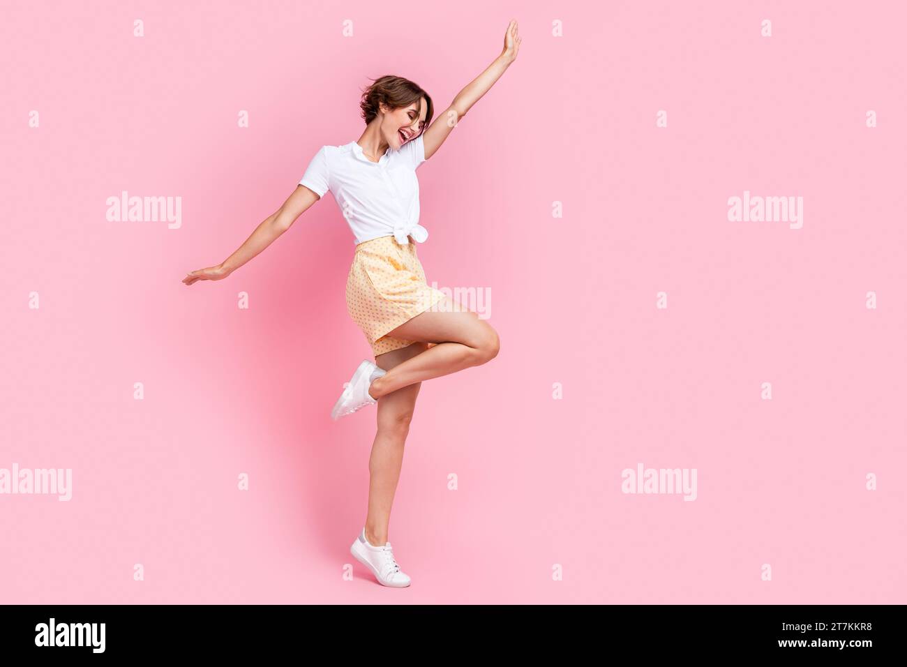 Full body cadre of nice energetic clubbing girl raised hand up positive ...