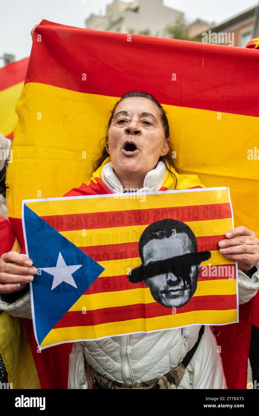 A woman holds a Catalan pro-independence "Estelada" flag depicting ...