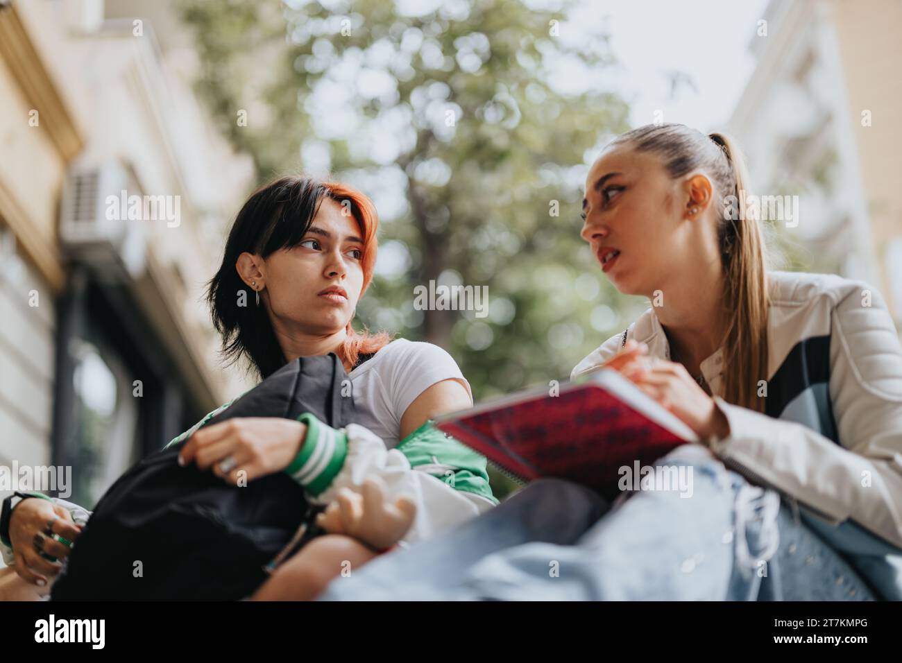 Two Young Girls Enjoying Learning Together Outdoors After Classes Stock ...