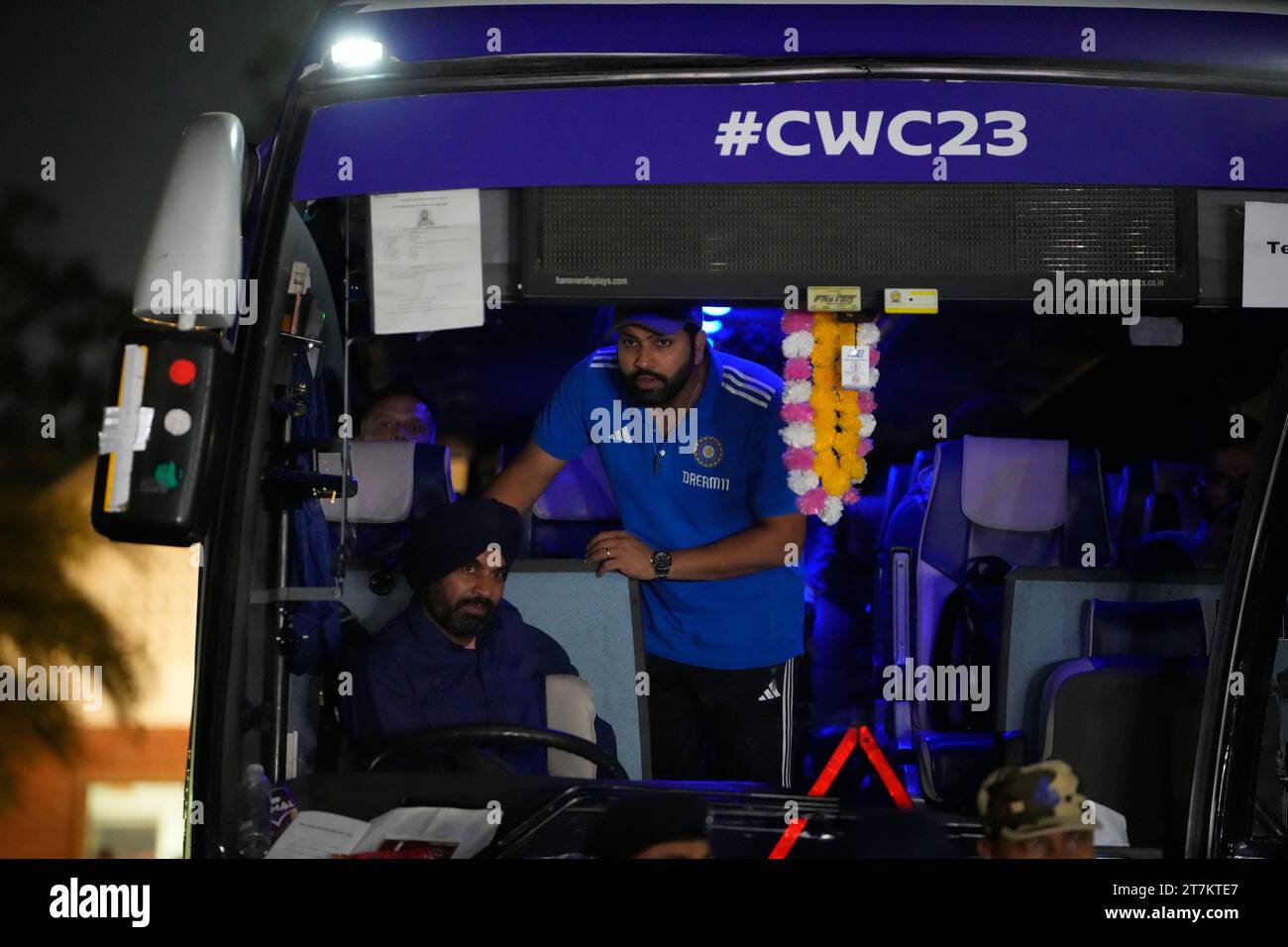 India's captain Rohit Sharma stands inside a bus as the Indian team ...