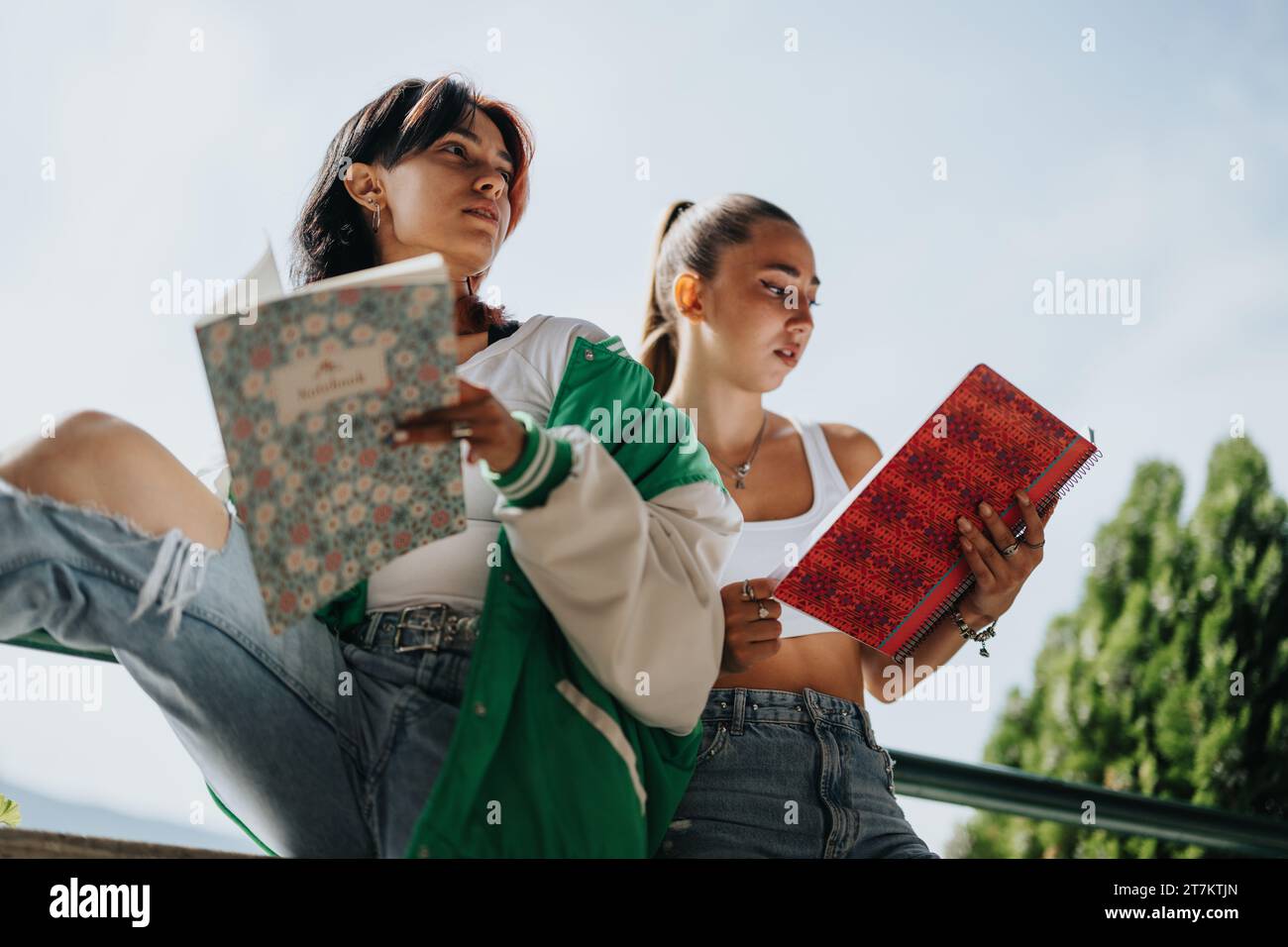 Two students study together in the city, discussing a school project ...