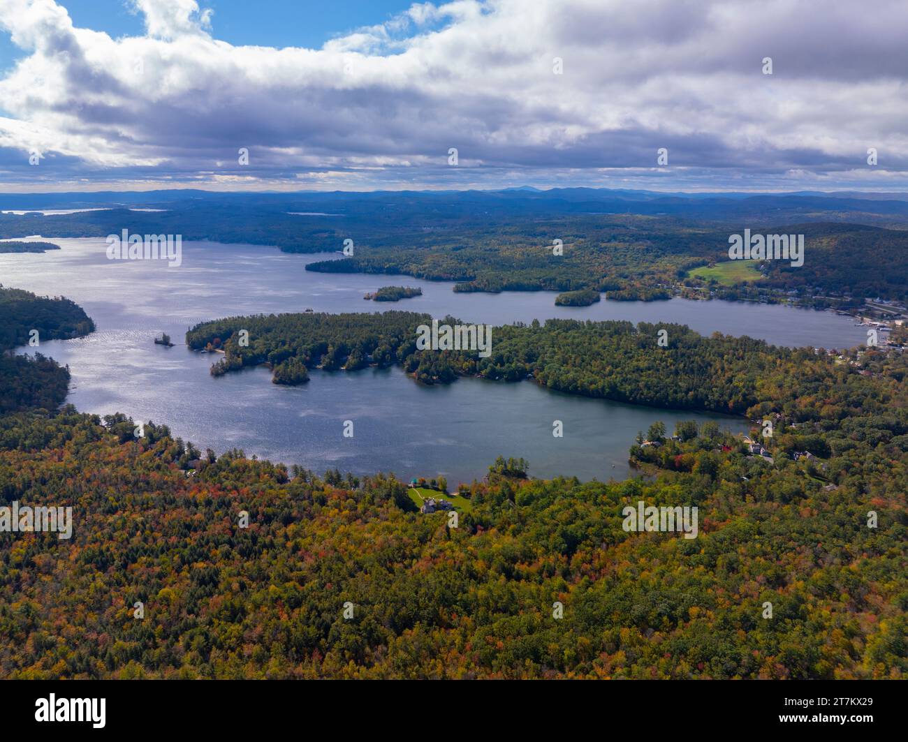 Aerial view of Lake Winnipesaukee with sunshine through clouds in fall ...