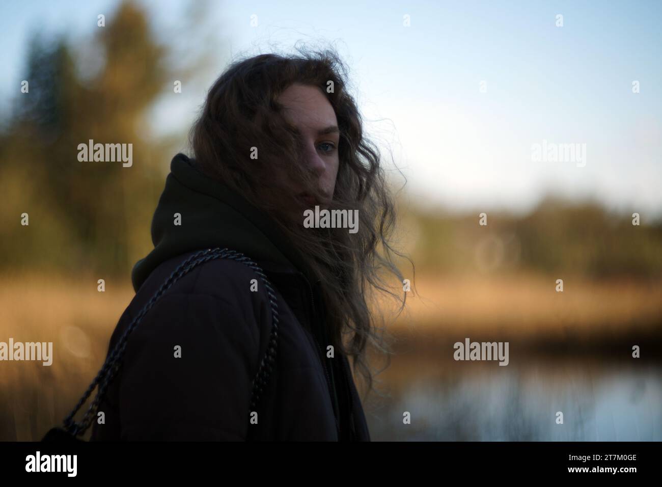 beautiful young woman with an anxious look. girl with strands of facial ...