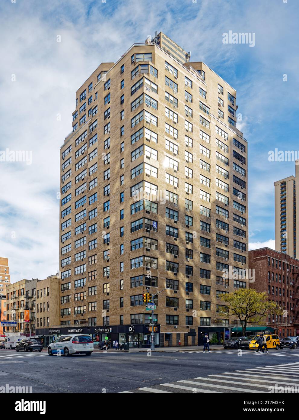 399 East 72nd Street, a brick apartment building with stores designed ...