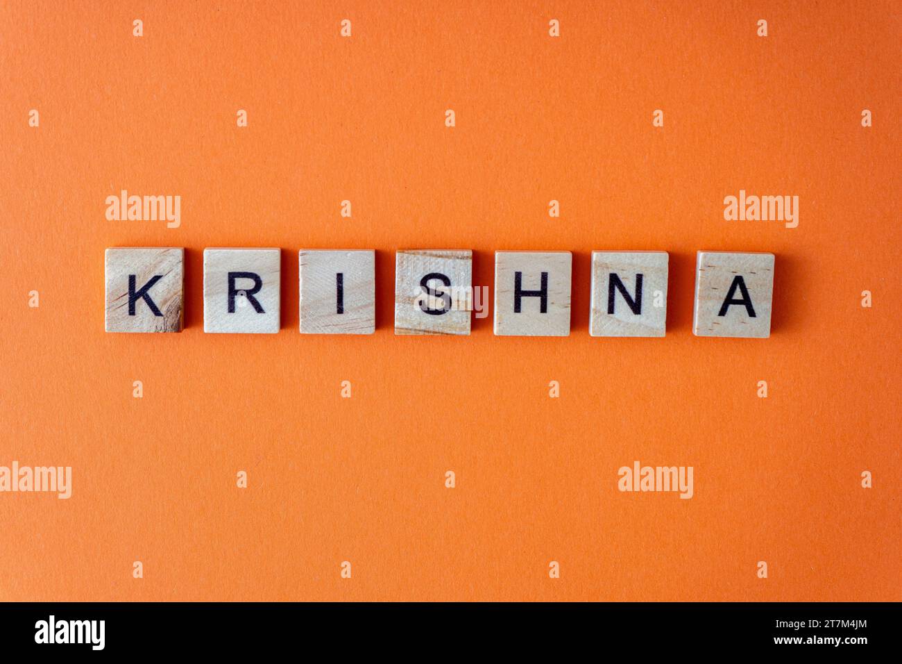 Krishna word. The phrase is laid out in wooden letters top view. Orange ...