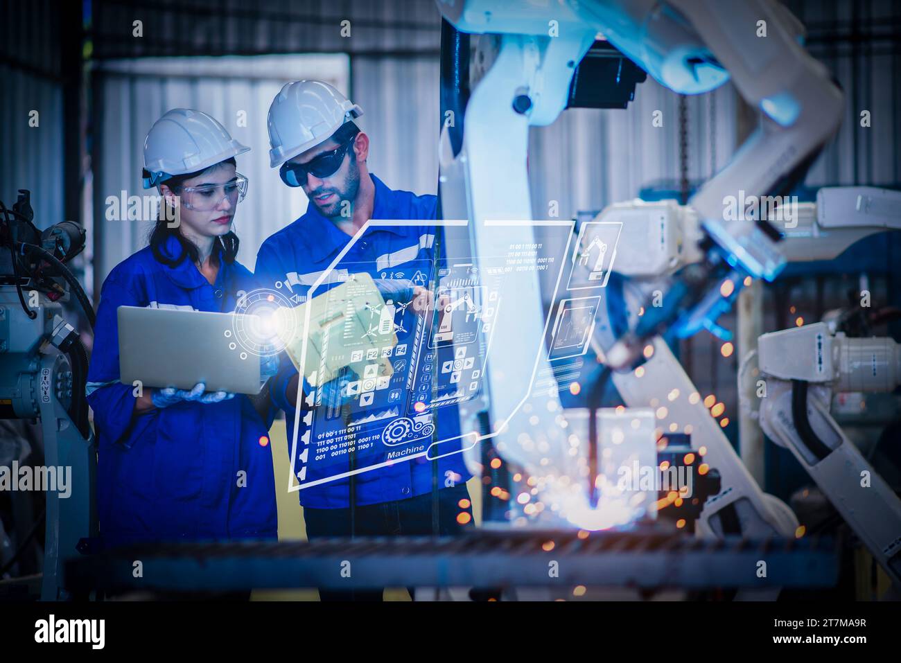 Two engineers mechanic using computer controller Robotic arm for ...