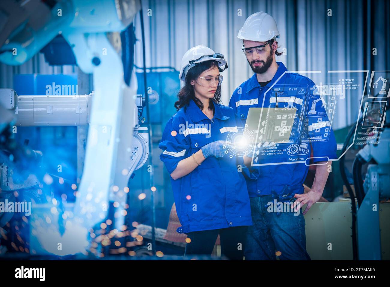 Engineers team mechanic using computer controller Robotic arm for welding steel in steel factory ...