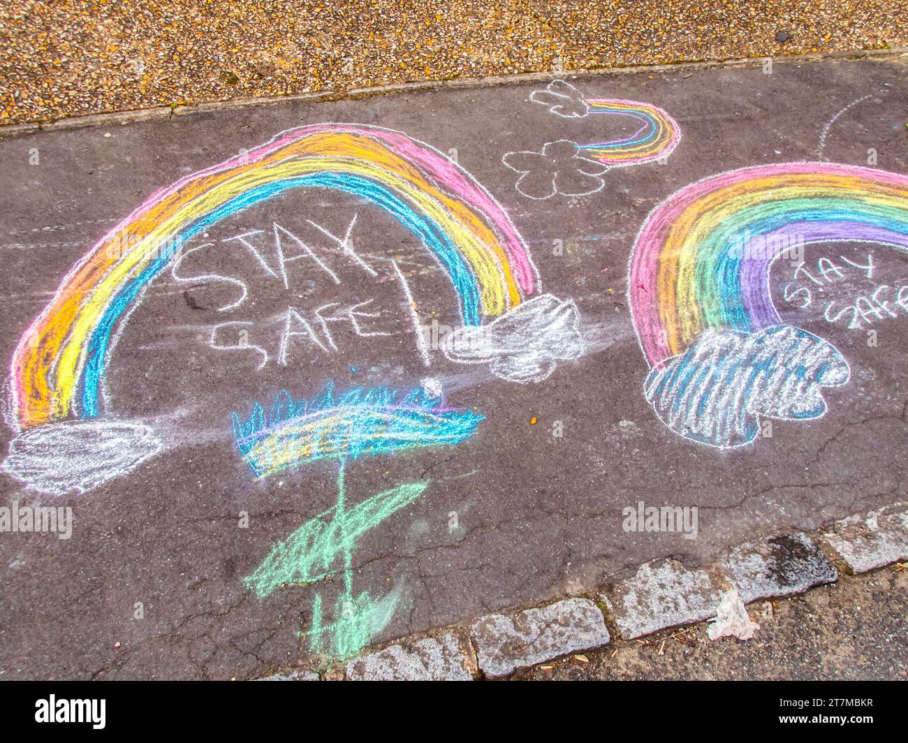 A colorful stay safe chalk drawing on pavement made by children at the ...