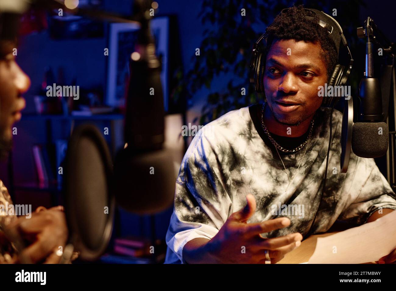 Focus on African American guy talking in microphone during ...
