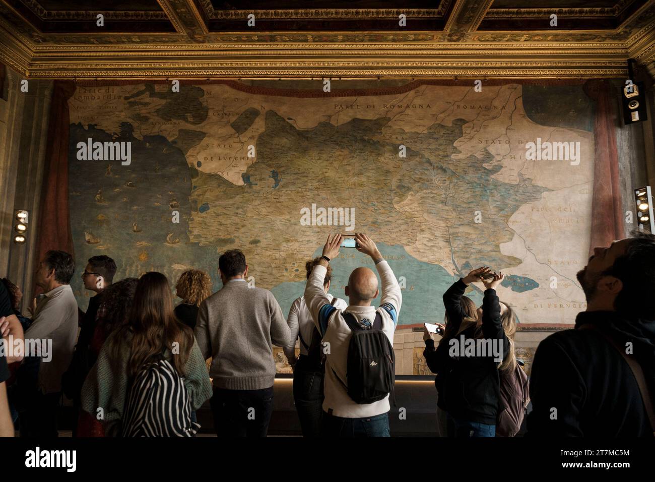 A diverse group of people visiting the museum in Florence, Italy ...