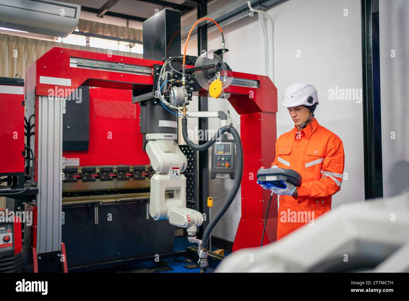 Engineers mechanic using computer controller Robotic arm for welding steel in steel factory ...