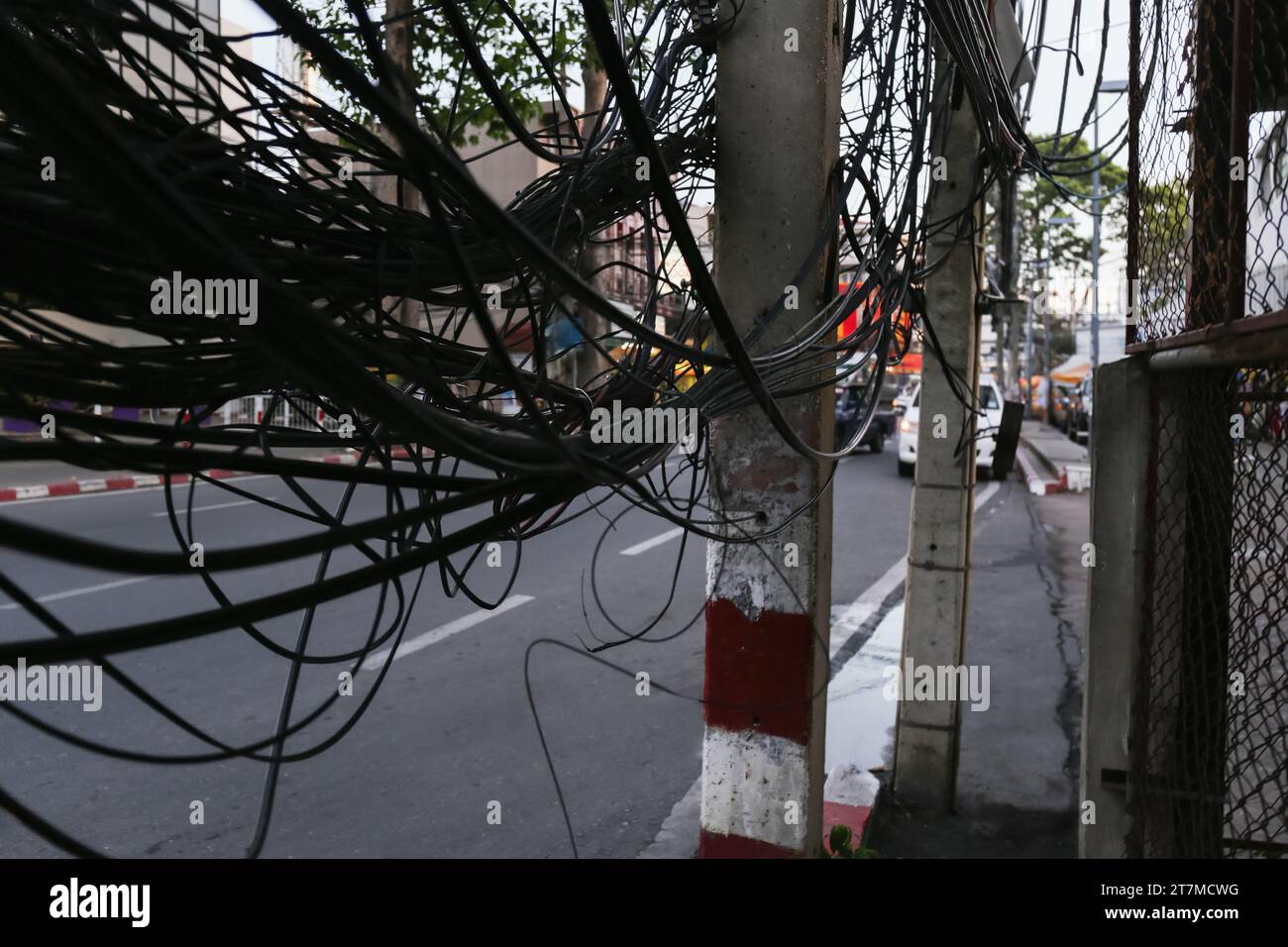 Chaotic cables and wires on an electric pole in Thailand, electrical supply in cities with ...