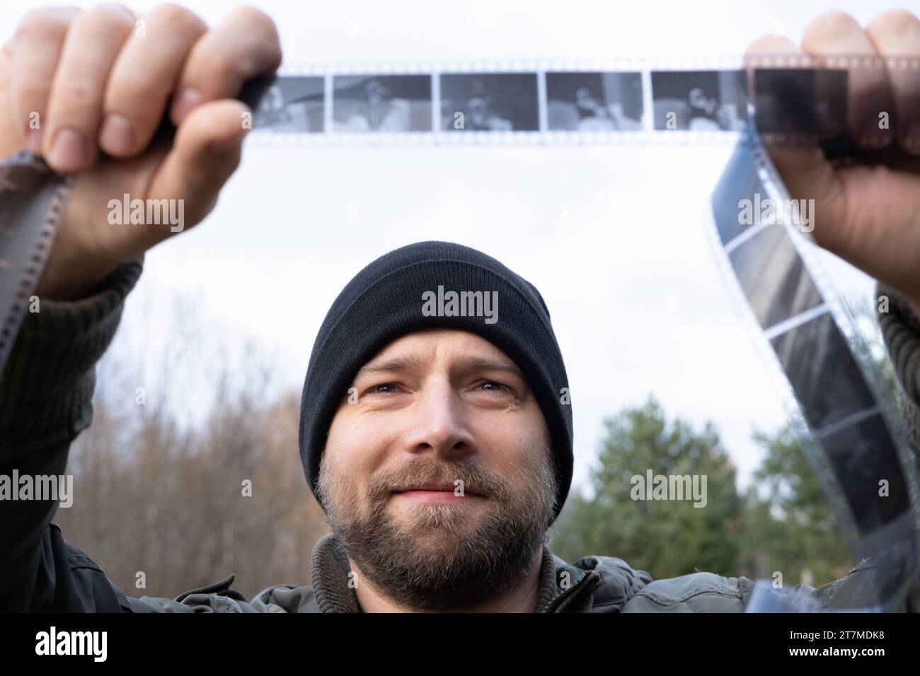 Man looks with interest at a vintage photographic film. Concept of ...