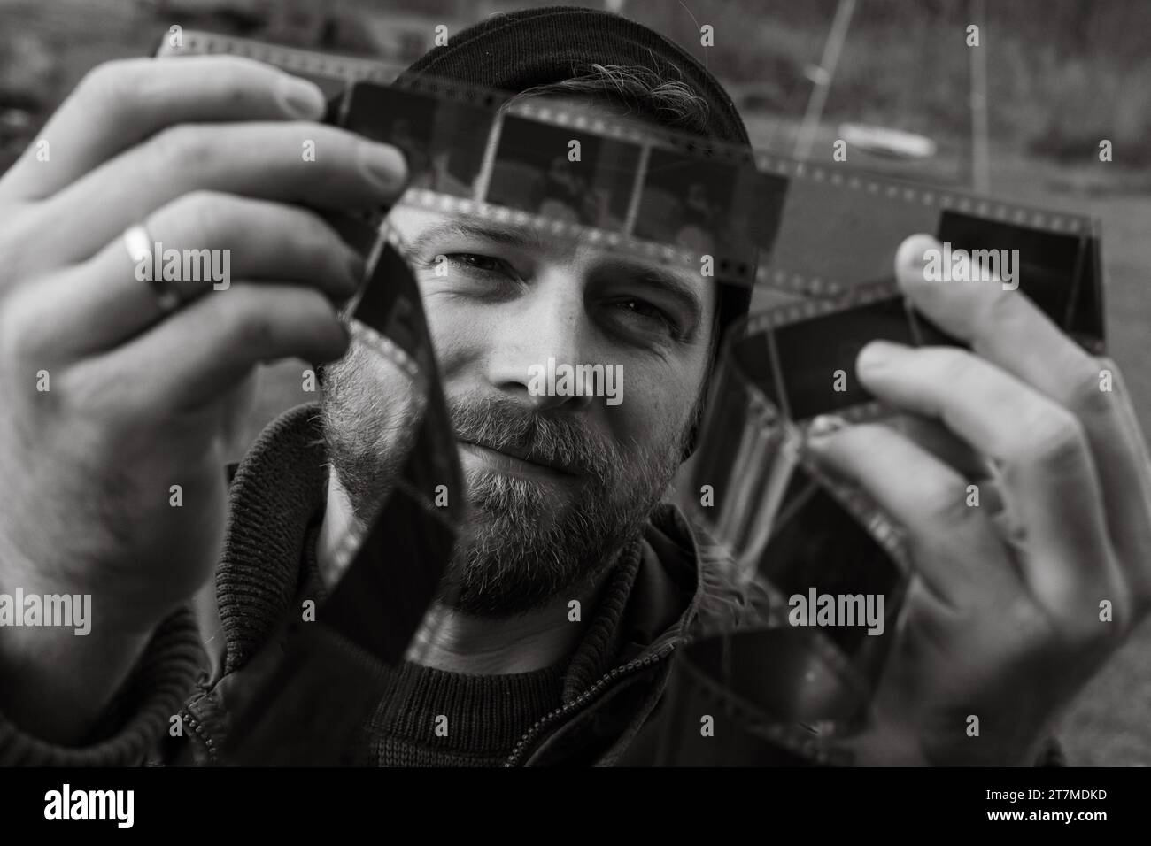 Man looks with interest at a vintage photographic film. Concept of ...