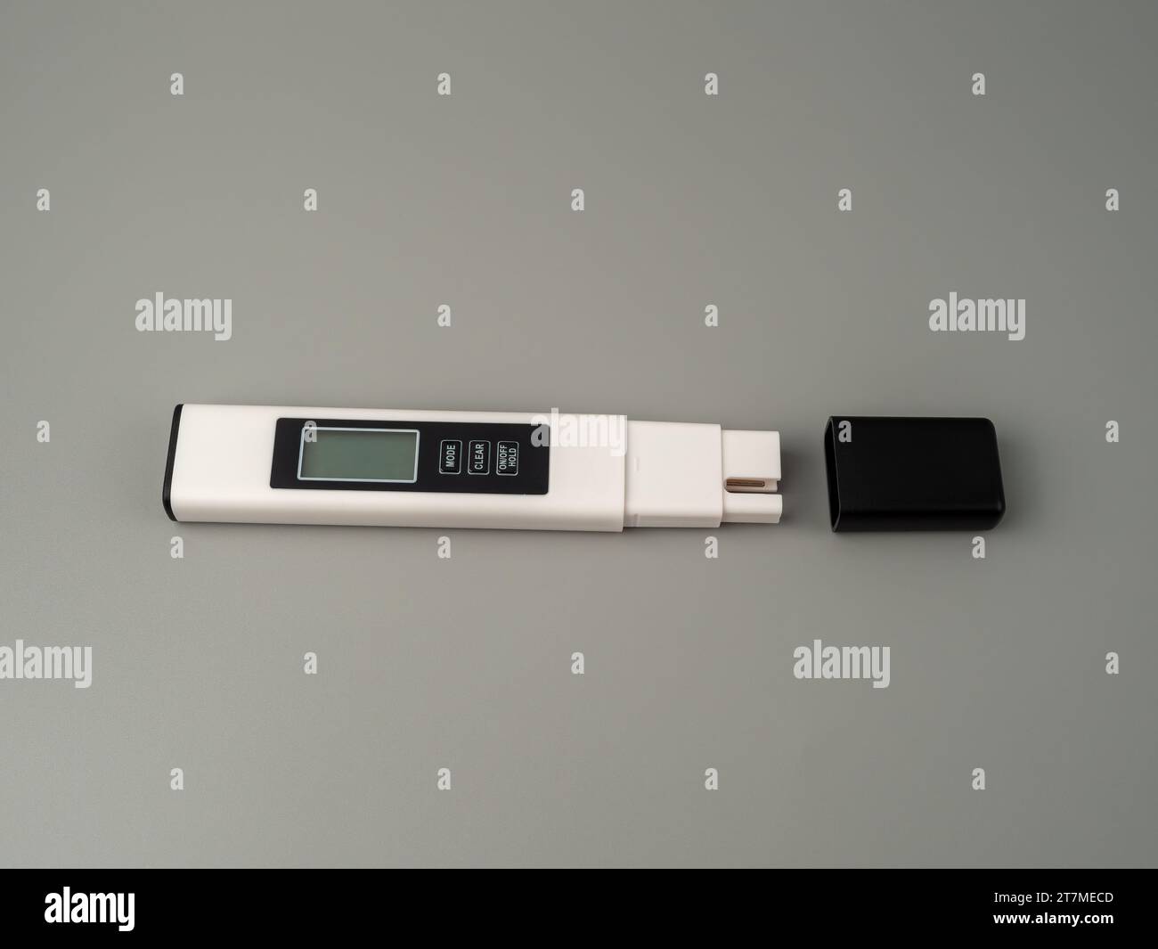 Water quality tester on a gray background. Device for measuring water ...