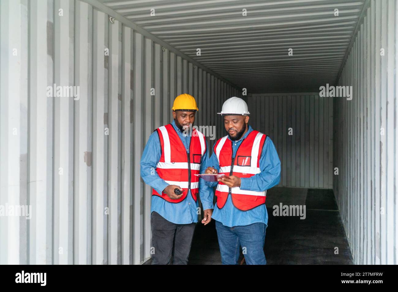 Portrait of Two African Engineer or foreman wears PPE checking ...