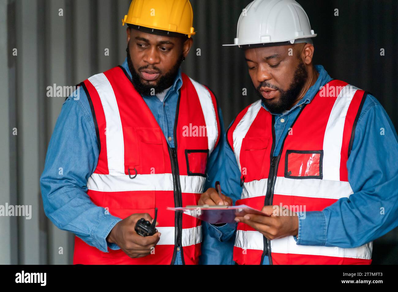 Portrait of Two African Engineer or foreman wears PPE checking ...