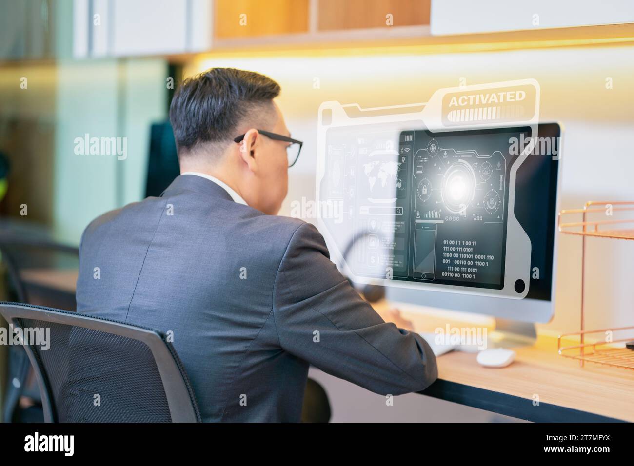Businessman looking at a computer monitor during his working day in the ...