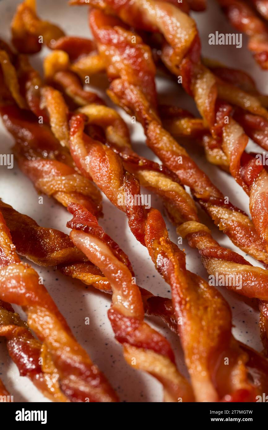 Homemade Trendy Twisted Bacon Strips on a Plate Stock Photo - Alamy