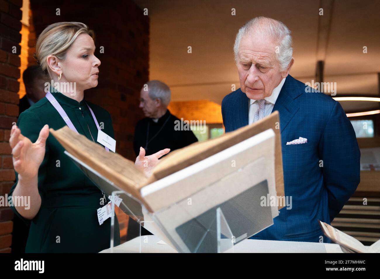 King Charles III looks at religious books during a reception of faith ...