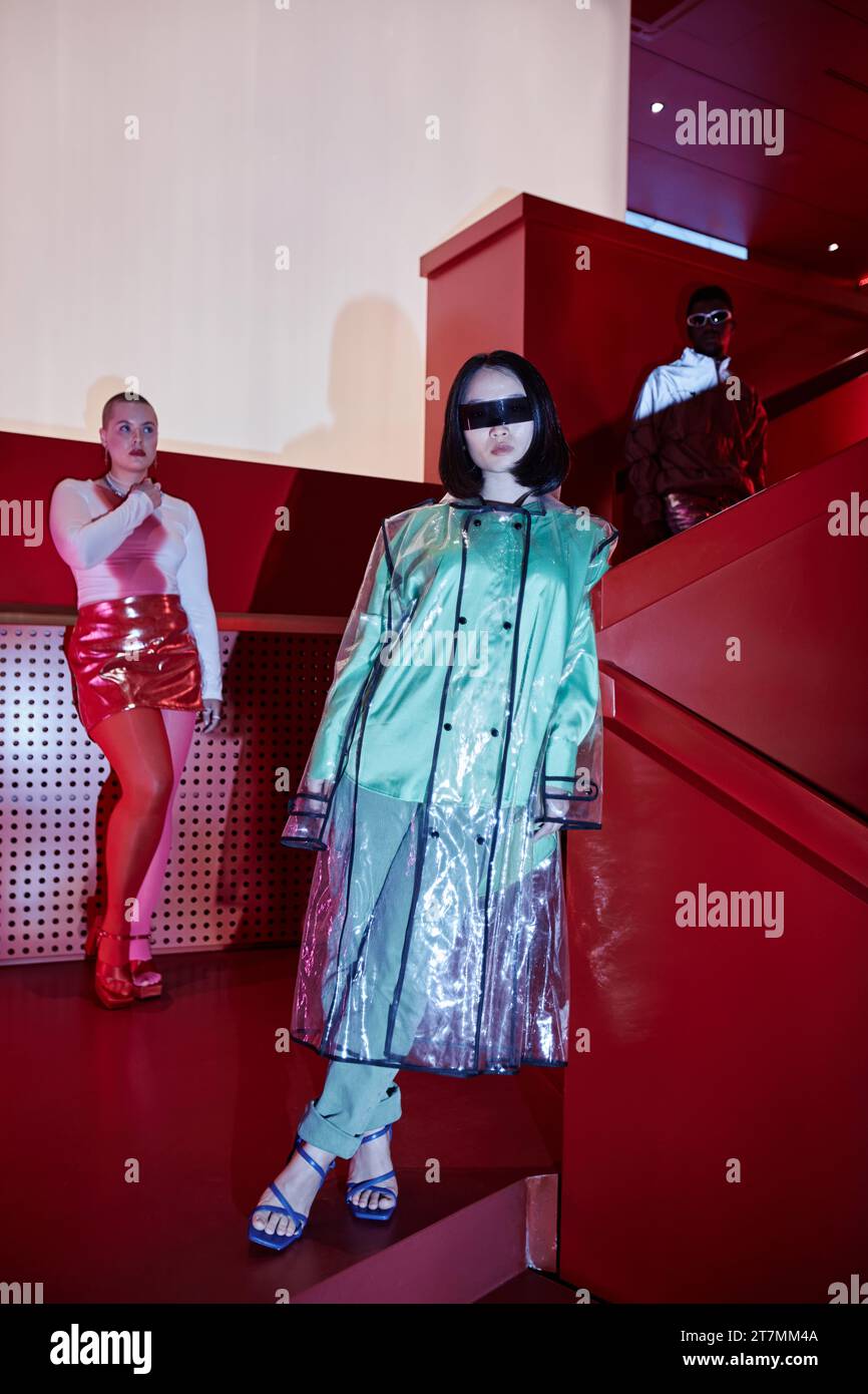 Group of young people wearing cyberpunk outfits posing in futuristic ...