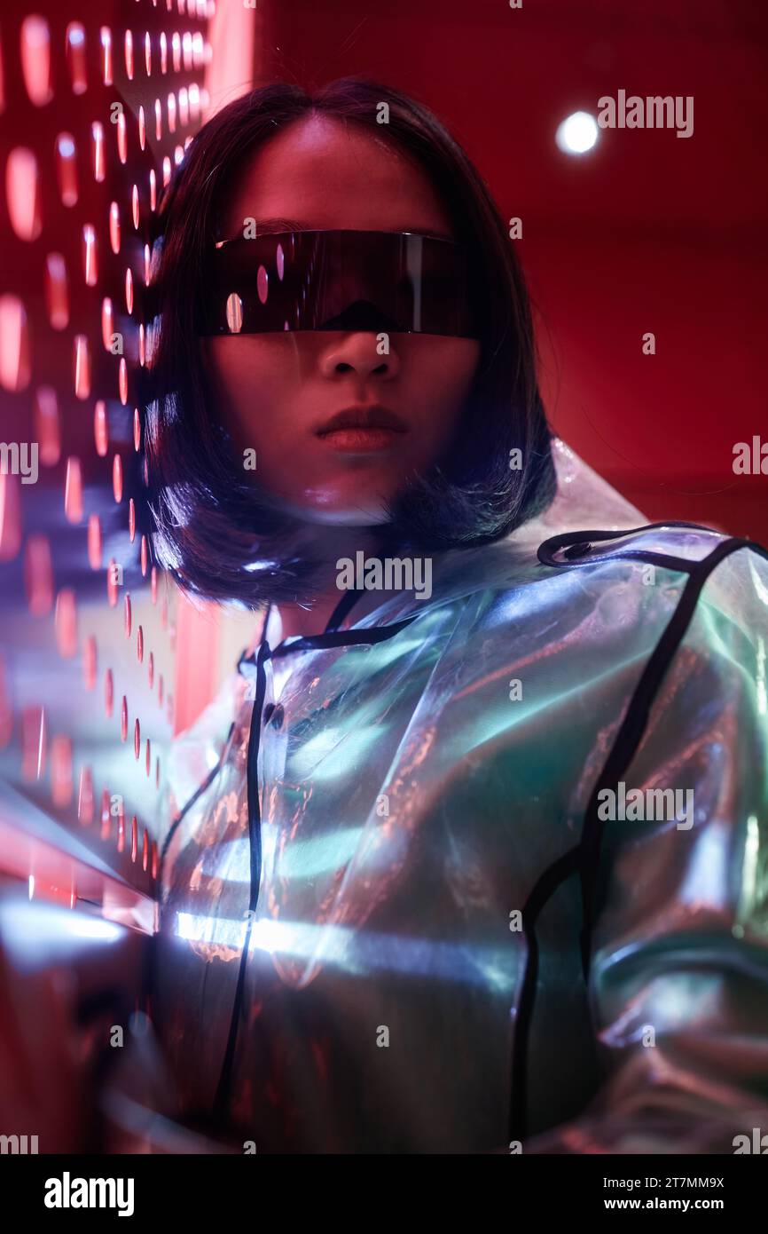 Vertical closeup portrait of young Asian woman wearing cyberpunk style ...