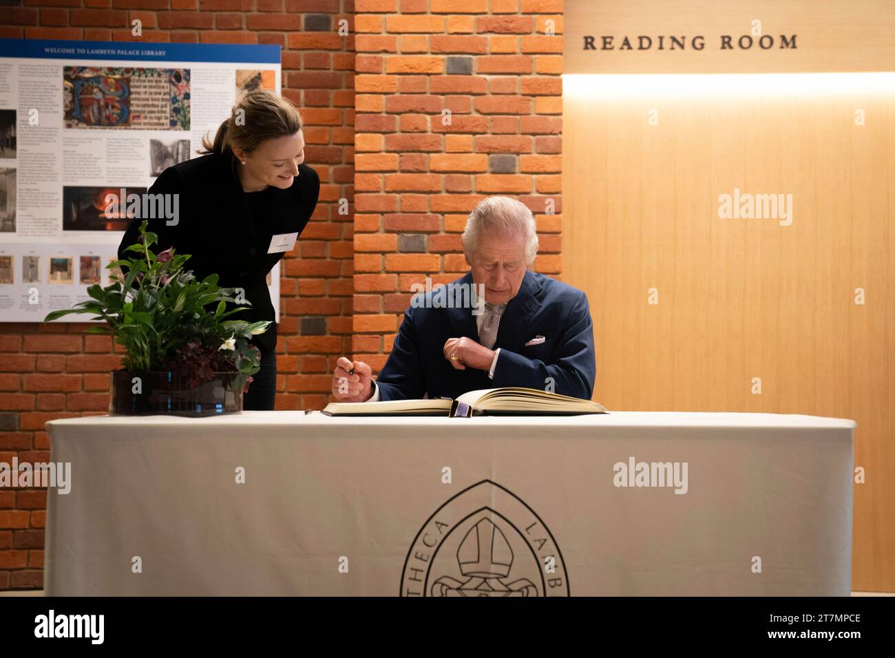 Britain's King Charles III signs a visitors book at a reception of ...