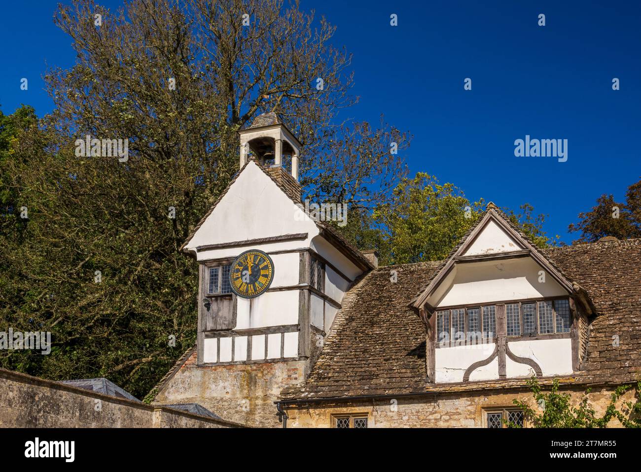 The tudor-style architecture of the courtyard and clock tower at Lacock ...