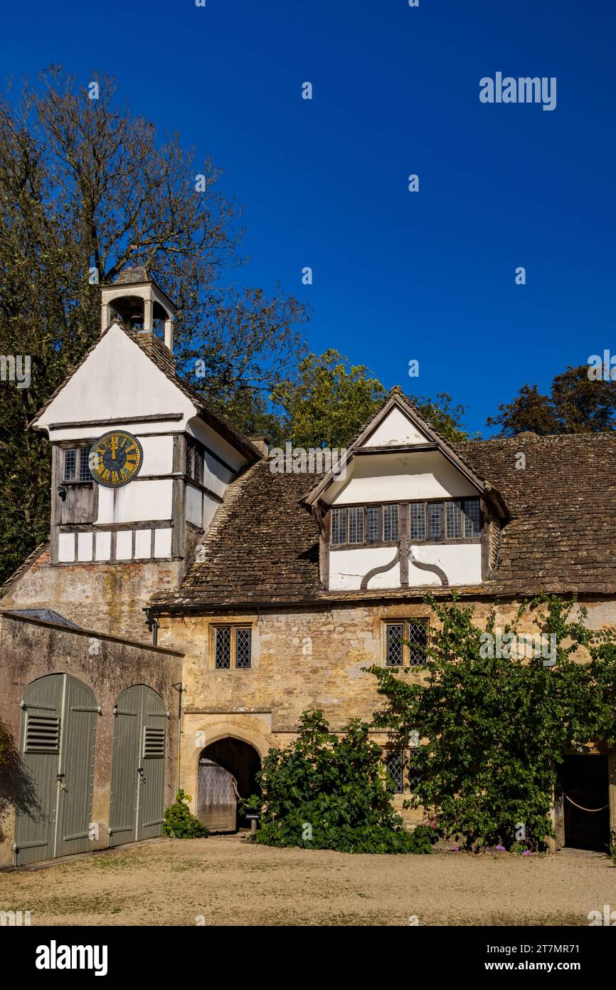 The tudor-style architecture of the courtyard and clock tower at Lacock ...