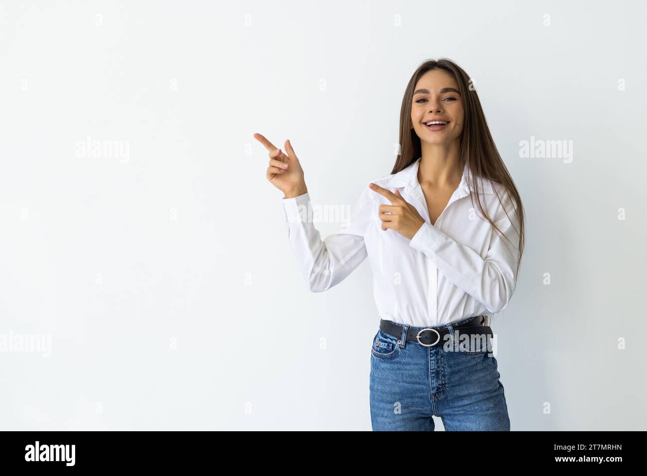 Smiling woman pointing finger side. Isolated portrait on white Stock ...