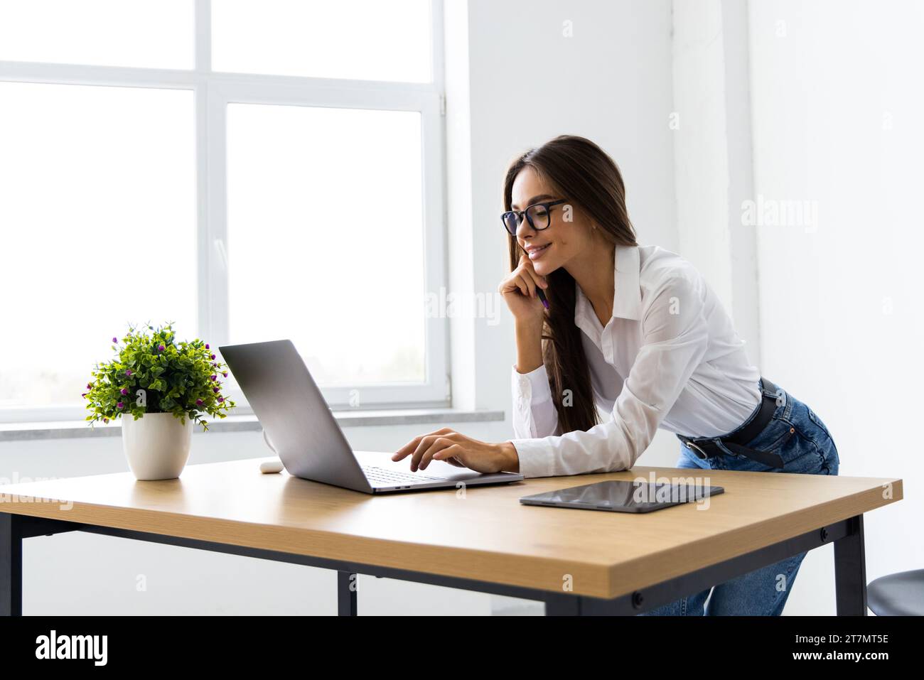Cheerful woman programmer at work inside modern office, tech support ...